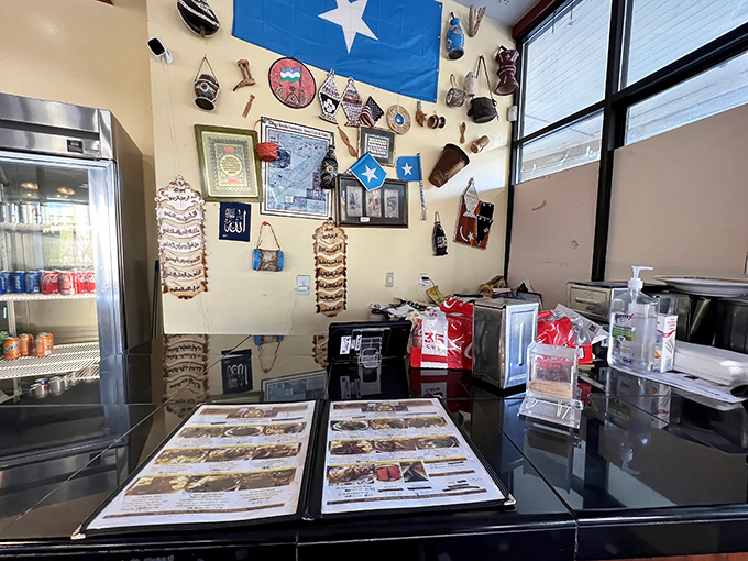 The counter where culinary dreams come true, complete with menus, Somali flag, and the promise of dishes worth writing home about.