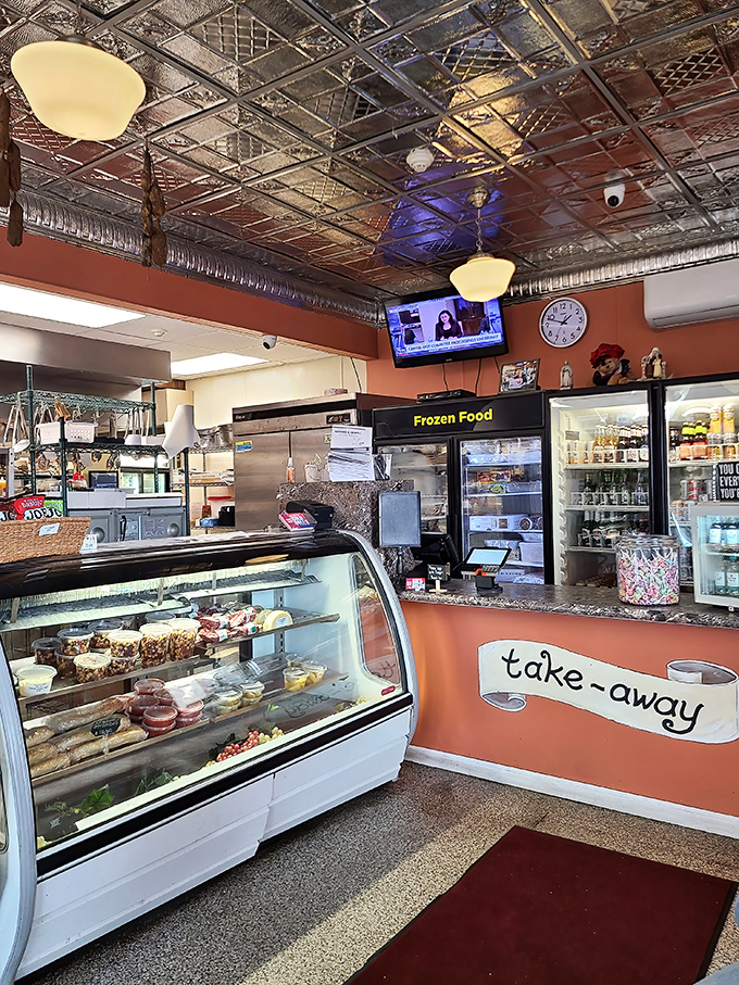 The take-out counter where dreams come true in cardboard boxes. That dessert case is like a museum of Italian-American sweet treasures waiting to be discovered.