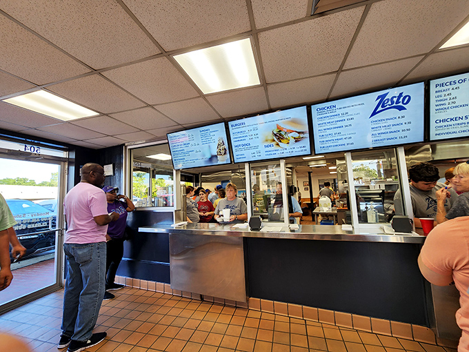 The counter where dreams come true, one order at a time. That menu board has witnessed more food fantasies than a midnight refrigerator raid.