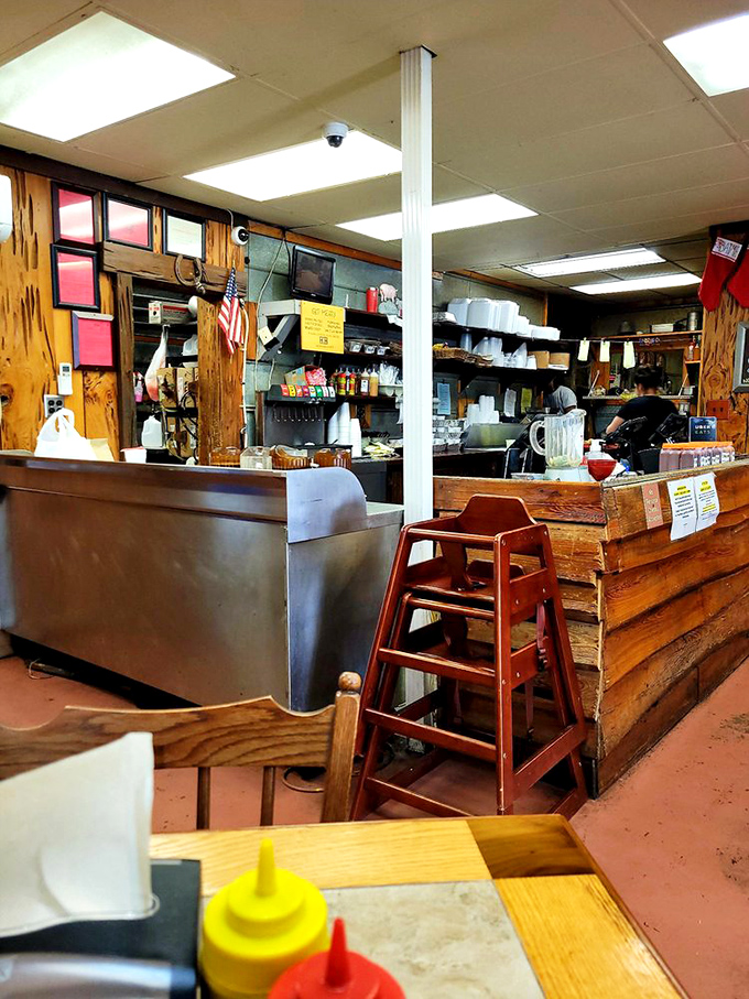 Behind this counter, BBQ magic happens daily. The wooden fa&ccedil;ade has absorbed decades of smoky wisdom and customer satisfaction.