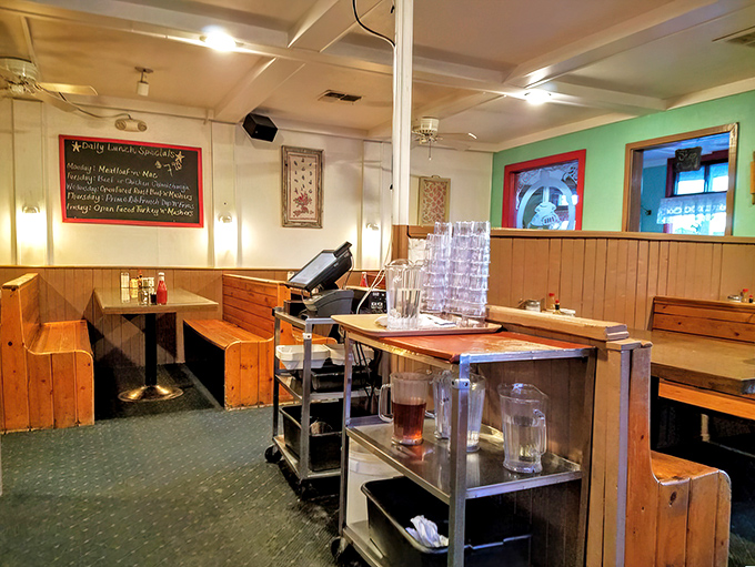 Where breakfast magic happens! That chalkboard hints at daily specials that locals plan their weeks around. The stack of water glasses stands ready for thirsty hikers.