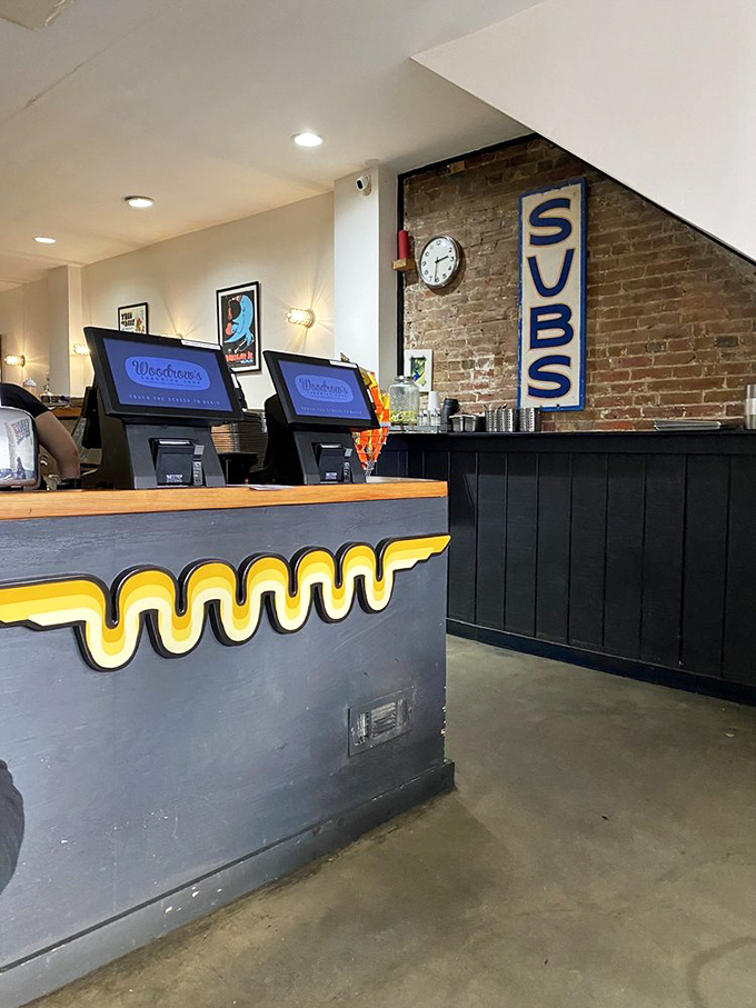 The counter's wavy yellow stripe is like a neon breadcrumb trail leading hungry customers to sandwich nirvana.