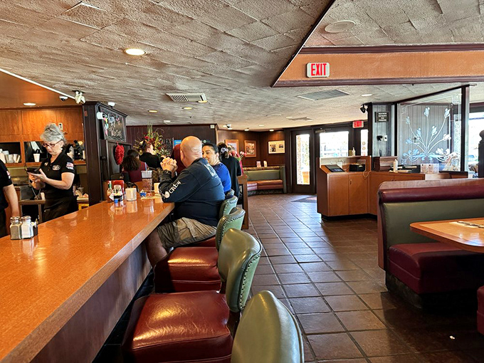 That counter runs like a neighborhood fence where strangers become friends over coffee refills and shared menu recommendations.