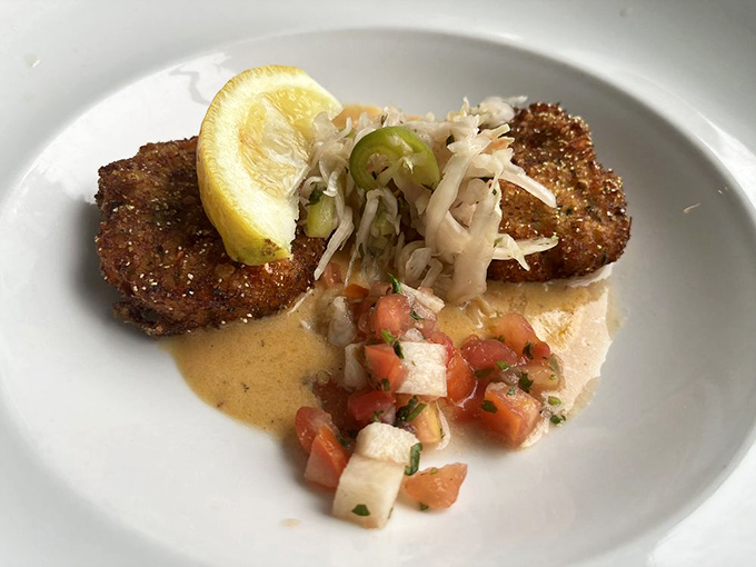 Crab cakes that are actually crab, not breadcrumbs with a seafood rumor. That fresh salsa adds brightness to every rich, savory bite.