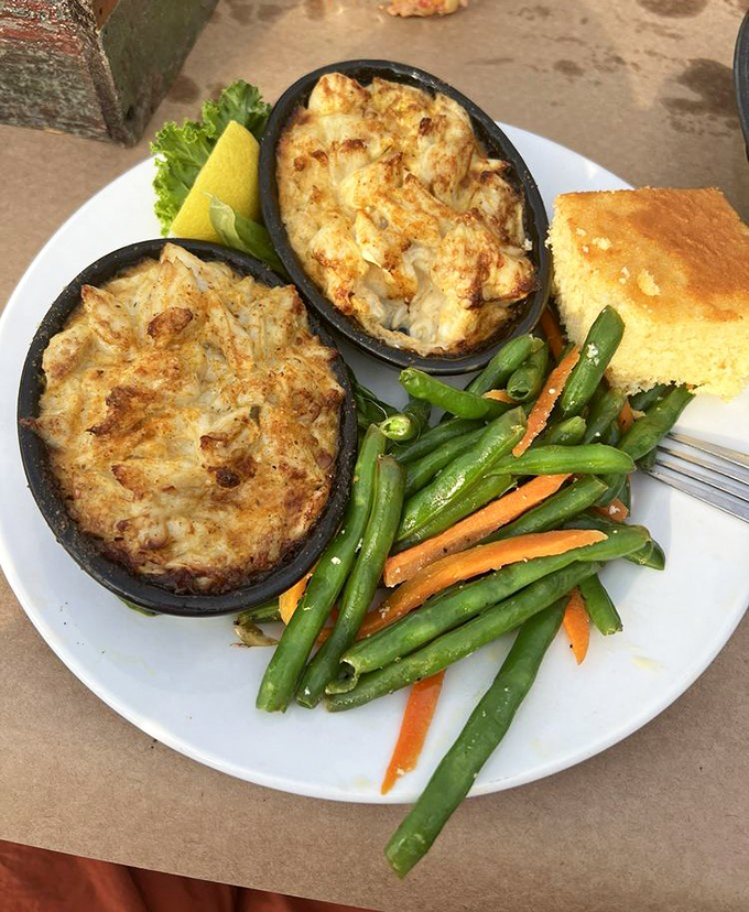 Crab imperial&mdash;where crab meat goes to achieve its highest purpose. Two ramekins of pure Maryland bliss alongside vegetables pretending to be the main event.