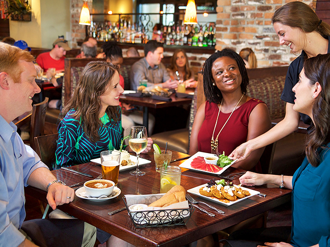 Outdoor dining at Harry's: where people-watching meets flavor-savoring under the iconic neon glow that beckons like a culinary lighthouse.