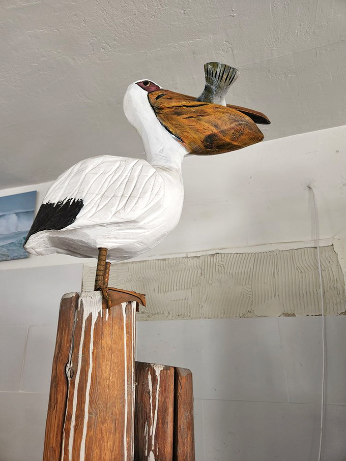 Whimsical wooden birds watch over diners like maritime guardian angels. In a world of cookie-cutter decor, these touches feel genuinely personal.