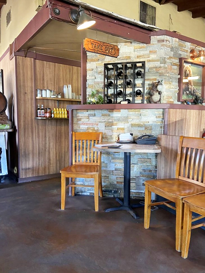 The take-out counter feels like stepping into a barbecue time machine. Those wooden chairs have heard decades of satisfied sighs.