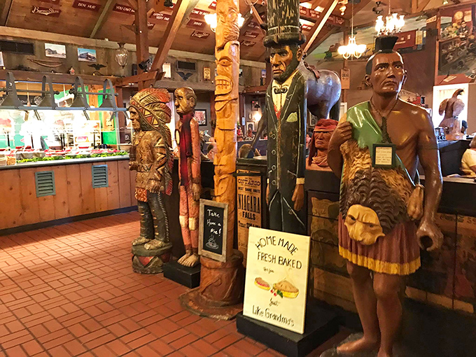Carved wooden figures stand guard over the dining experience like sentinels of satisfaction. That "Home Made Fresh Baked" sign speaks the truth.