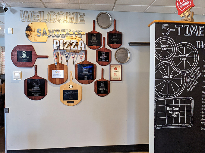 A wall of awards that tells you everything you need to know before your first bite. Trophy-worthy pizza isn't just a phrase here.