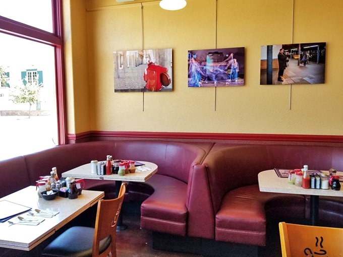 The burgundy booths aren't just seating&mdash;they're front-row tickets to the breakfast show. Yellow walls and art create that "neighborhood favorite" ambiance we all crave.