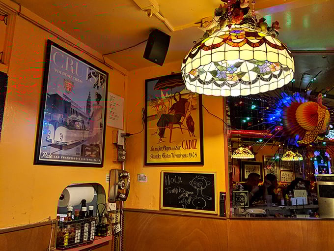 Vintage travel posters and warm lighting create an atmosphere where every meal feels like a mini-vacation from the ordinary.