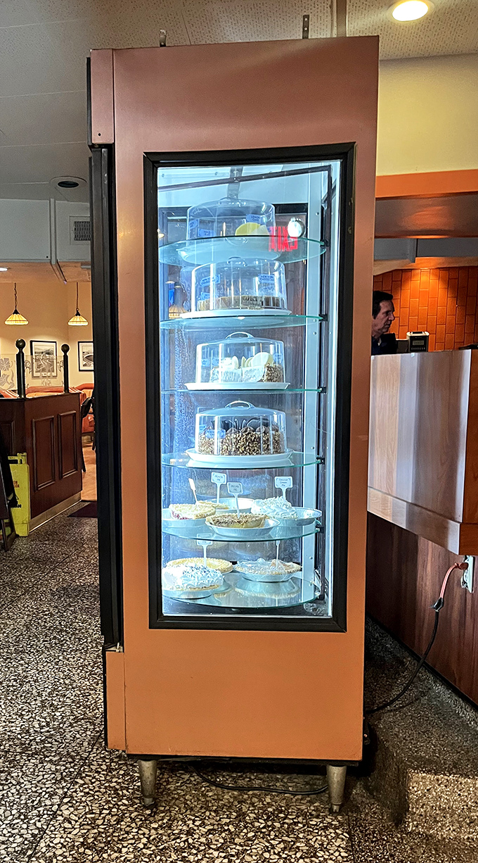 The rotating dessert case &ndash; a slow-motion temptation machine where willpower goes to die and "I'll just have coffee" becomes a lie.