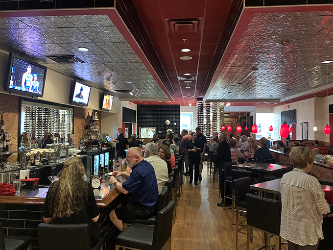 The bustling bar area where locals gather to debate important matters like which cut of beef pairs best with a bold cabernet.