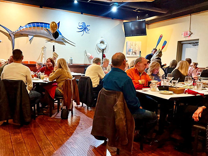 Diners enjoying the maritime-themed dining room, where seafood stories and satisfied smiles are always on the menu.