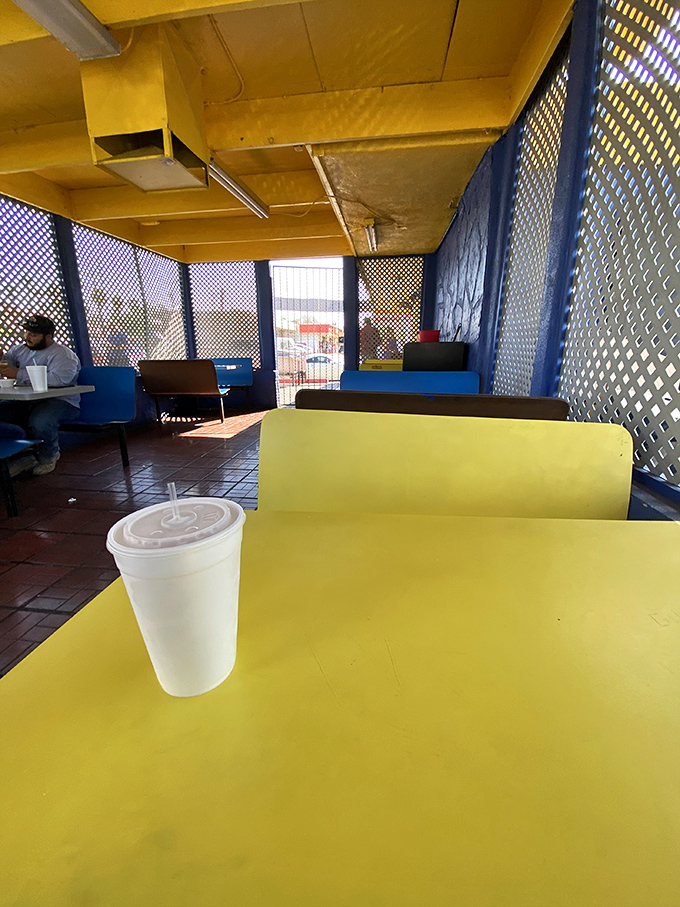 The sunny yellow tables and blue lattice create a cheerful backdrop for the serious business of enjoying authentic Mexican food.