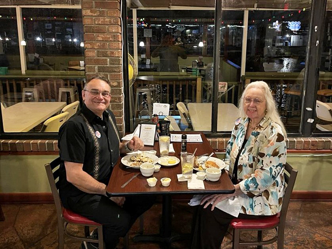 Happy diners experiencing what vacation commercials promise but rarely deliver: authentic Florida dining with plates worth remembering long after the suntan fades.