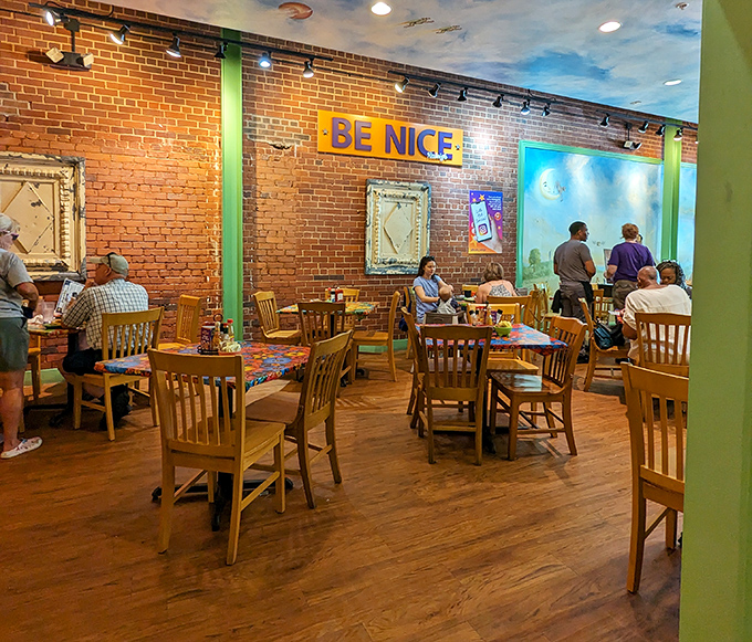 Exposed brick walls, wooden chairs, and a "BE NICE" sign&mdash;Southern hospitality isn't just served here, it's built into the architecture.