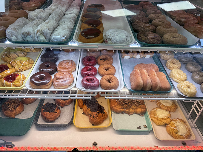 The donut display case &ndash; where willpower goes to die and breakfast dreams come true.