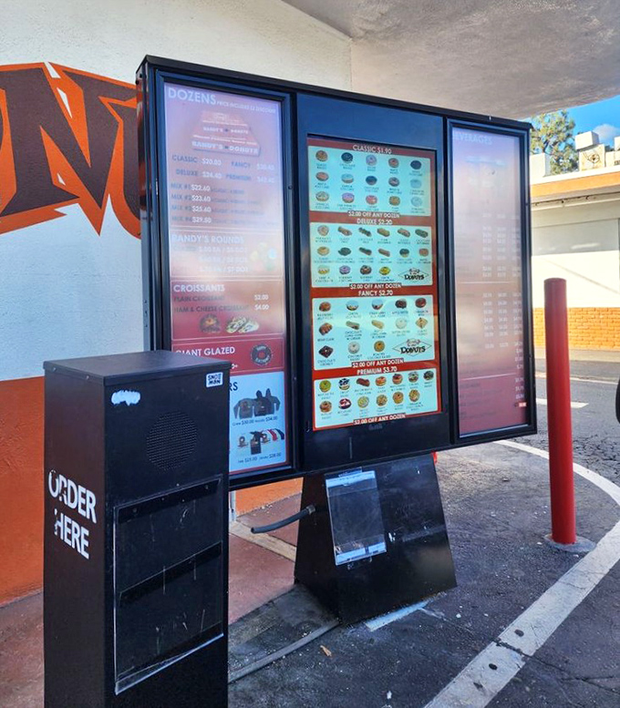 Modern convenience meets retro charm. Randy's drive-thru menu board proves you don't need to leave your car to experience donut nirvana.