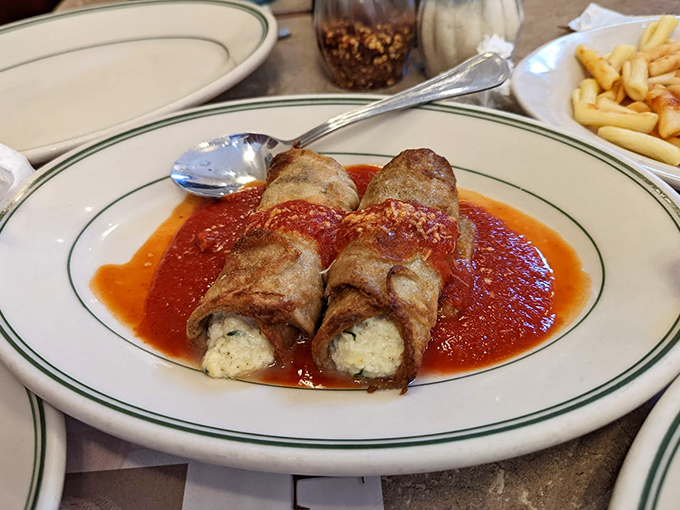 Eggplant ricottatini rolls lounging in marinara like they're at a luxurious spa bath &ndash; vegetarian food that makes carnivores question their life choices.
