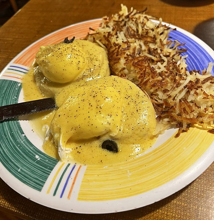 Eggs Benedict: where hollandaise sauce flows like liquid sunshine over poached eggs. Those hash browns are crispy supporting actors deserving applause.