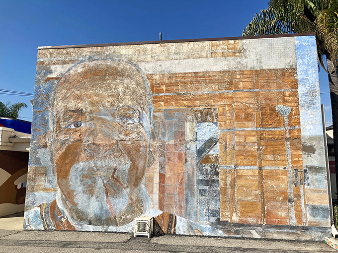 Street art meets historical homage in this weathered mural, a neighborhood reminder of the artistic legacy that continues to inspire.