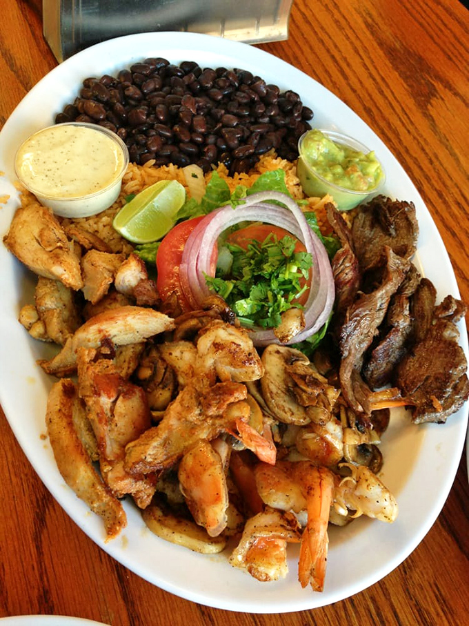 A plate that answers the eternal question: "Why choose between chicken, steak, and shrimp?" with a resounding "You don't have to!"
