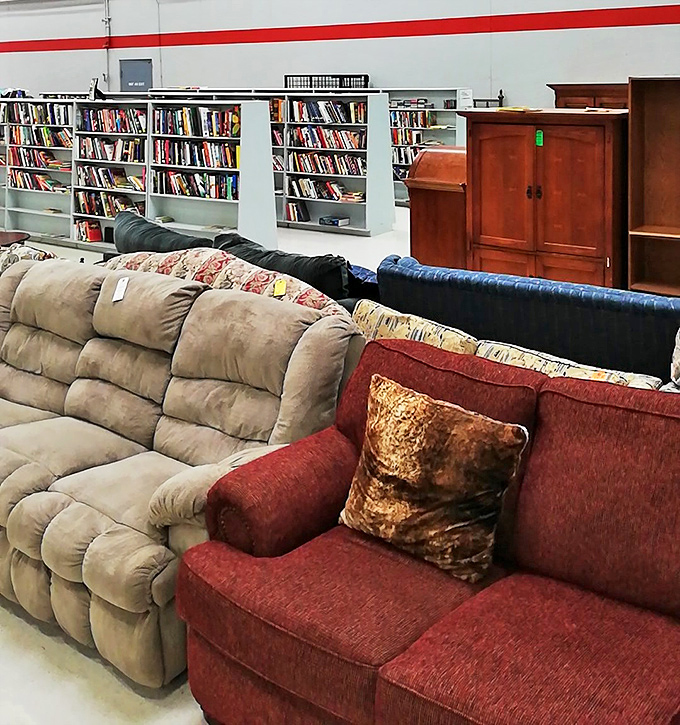 Furniture that tells stories sits patiently waiting for its next chapter. That red couch has seen things, and now it's ready to see your living room.