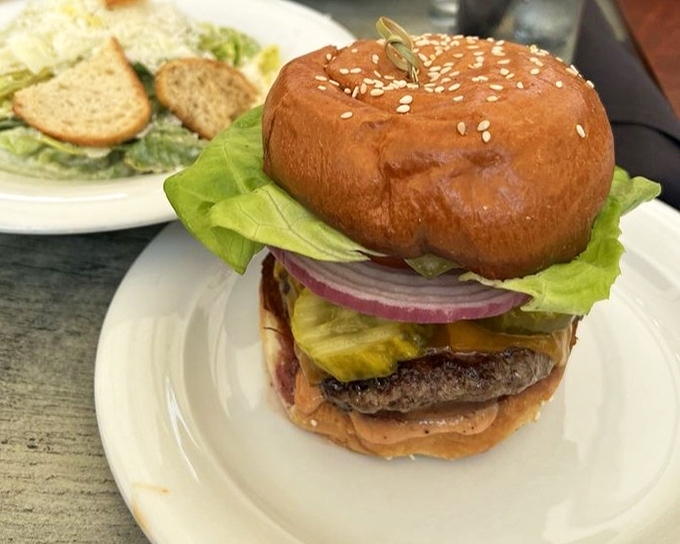 This isn't just any burger&mdash;it's architectural perfection with melted cheese cascading down a perfectly charred patty. Napkins required, regrets impossible.