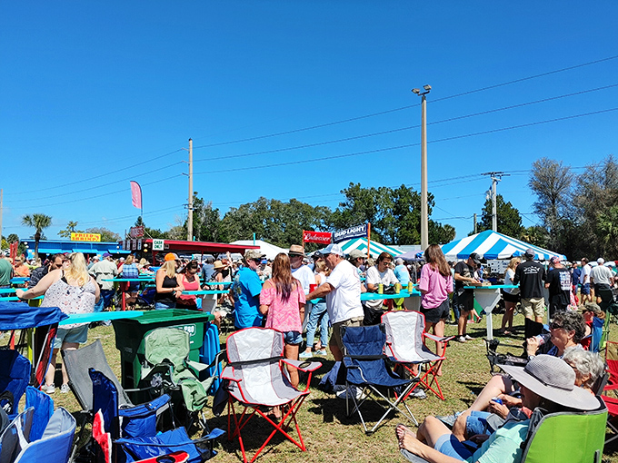 Festival-goers gather under Florida's brilliant blue skies. The Grant BBQ Festival transforms this quiet town into a smoky paradise of grilled delights.