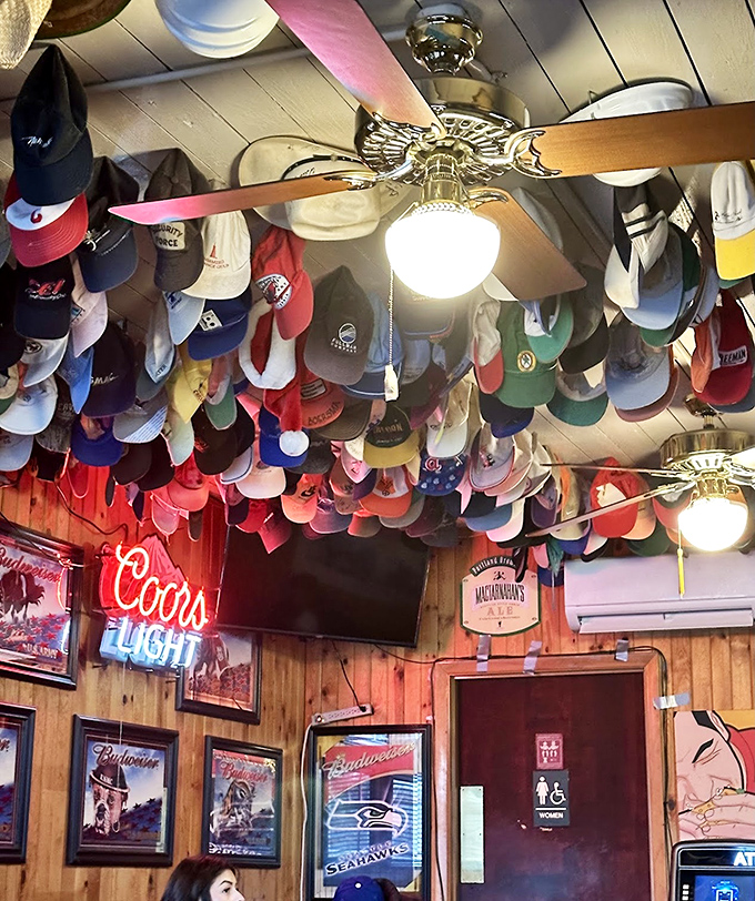 The ceiling collection that started with one forgotten cap and evolved into Oregon's most colorful upside-down hat museum.