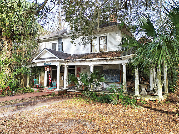 This weathered white house with its welcoming porch practically whispers "come sit a spell" in the most authentic Southern accent imaginable.