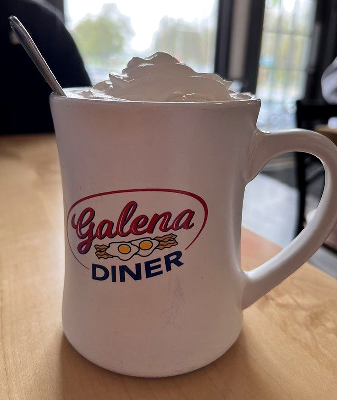 Hot chocolate topped with whipped cream perfection, because some comforts never go out of style here.