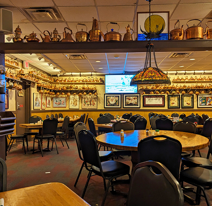 The copper collection continues into infinity, like a funhouse mirror for culinary enthusiasts. Those empty tables won't stay that way for long.