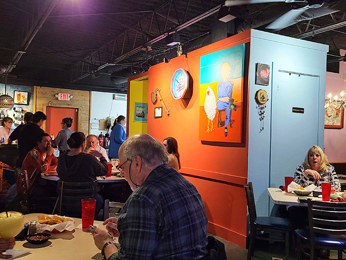 Where color therapy meets dinner therapy. The orange walls and whimsical chicken art create a space that feeds your soul before the food arrives.