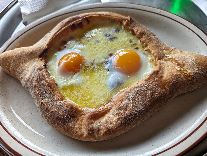 Khachapuri: Georgia's gift to cheese lovers everywhere. A boat-shaped bread cradles melted cheese and sunny egg yolks in a relationship that was clearly meant to be.