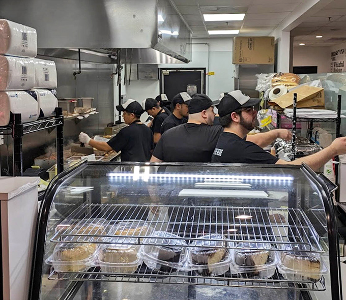 Behind-the-scenes heroes work their craft – a well-coordinated kitchen team ensures every sandwich meets the Cheesesteak & Co. standard.