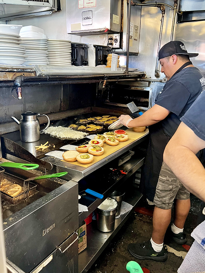 The kitchen dance &ndash; where burgers meet buns and onions sizzle into submission on a grill seasoned by decades of use.