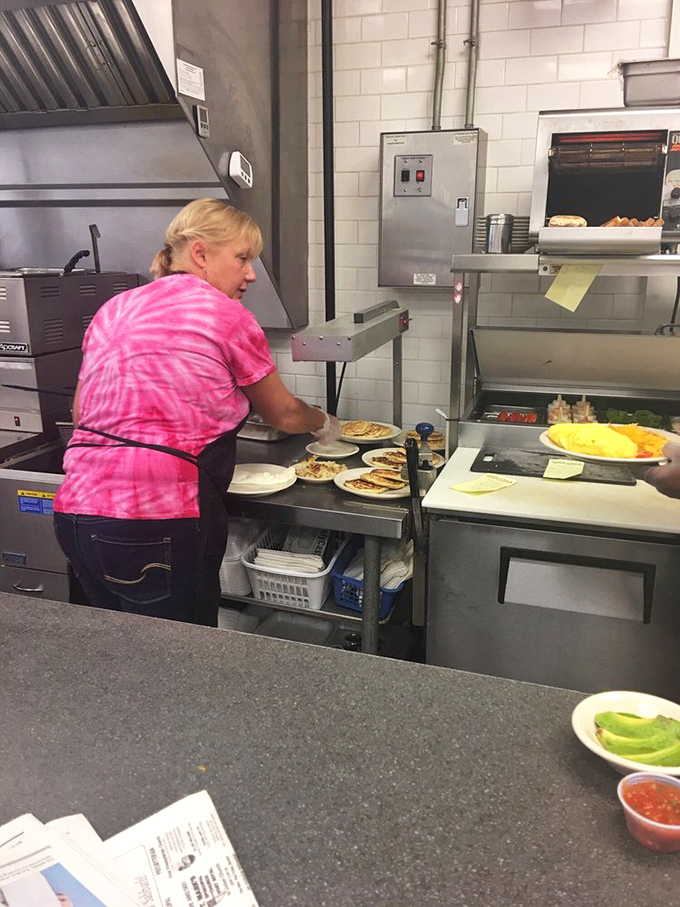 Behind-the-scenes breakfast magic. Those tie-dye shirts add unexpected flair to the serious business of pancake perfection. 