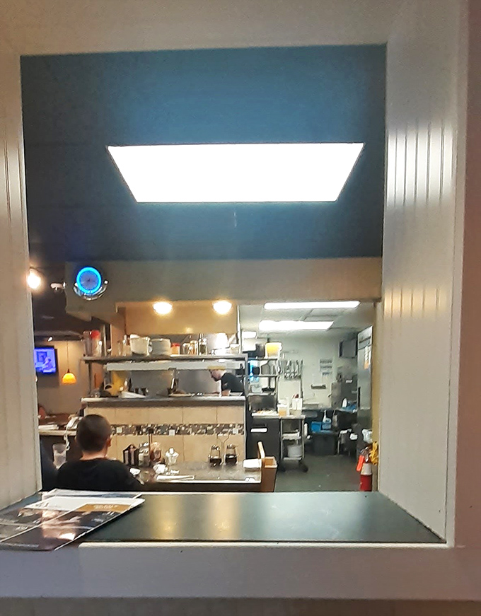 Behind every great breakfast is a kitchen where the real magic happens. This pass-through window offers a glimpse into the orchestrated chaos that delivers your morning joy.