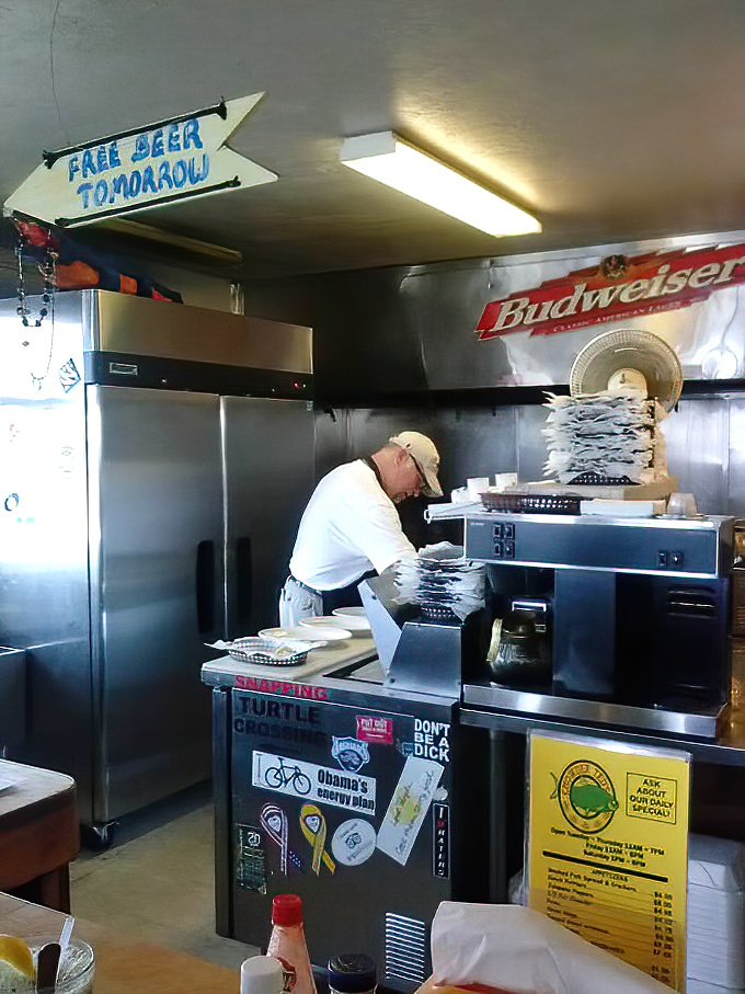 Behind every great seafood joint is a kitchen with character. That "Free Beer Tomorrow" sign has probably been there since opening day.