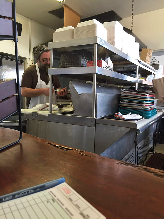 The kitchen ballet&mdash;where orders become meals through practiced movements and quiet concentration. No molecular gastronomy, just honest cooking.