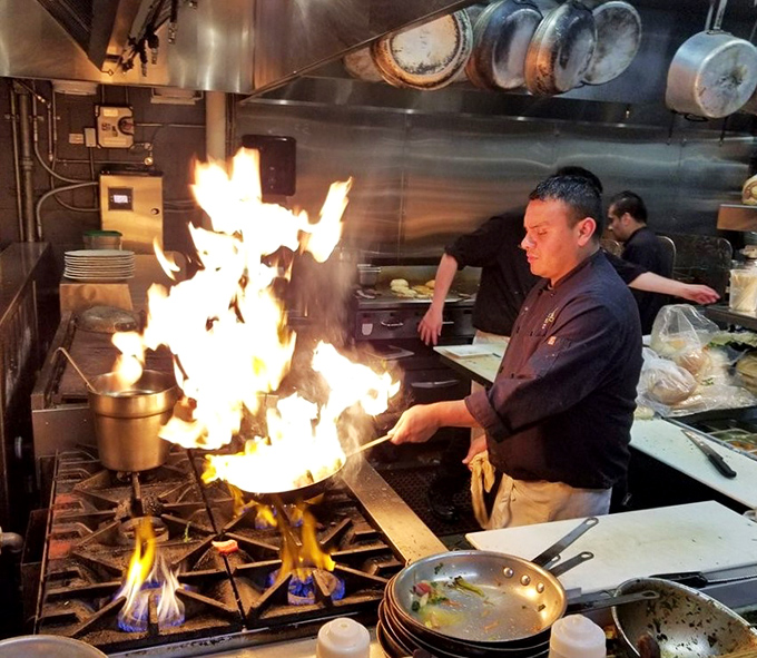 Flames leap dramatically in the open kitchen. This isn't just cooking&mdash;it's culinary theater where fresh seafood gets the star treatment it deserves.