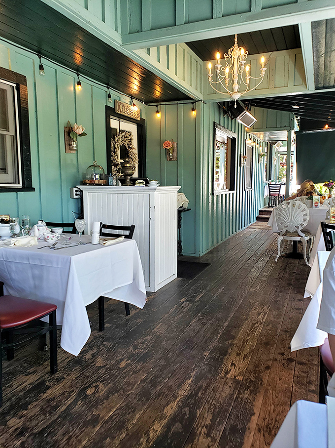 Mint-green walls and weathered wood floors create the perfect canvas for white tablecloths and afternoon indulgence.