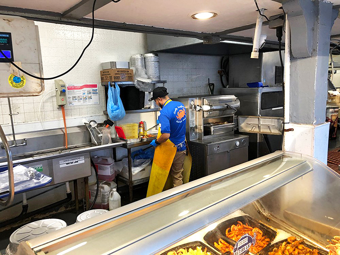 Behind-the-scenes seafood sorcery. This kitchen may not be fancy, but those hands know exactly how to transform creatures of the deep into edible art.