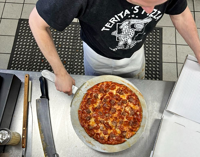 The pizza assembly line &ndash; where dough becomes art. Notice the practiced precision that comes from decades of perfecting the craft.