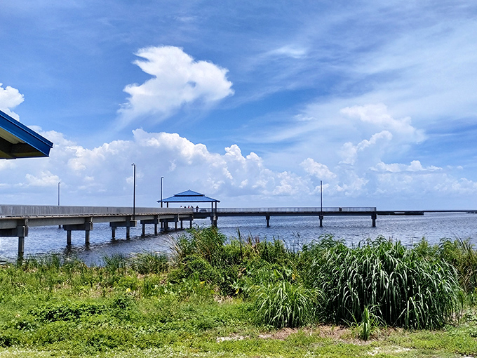 Lake Okeechobee's fishing pier stretches toward possibility. Where retirement dreams involve fishing rods instead of country club memberships.