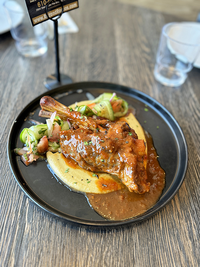 This lamb shank isn't just falling off the bone &ndash; it's practically filing for independence on a bed of creamy polenta.