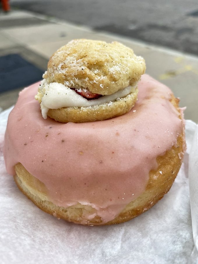 Strawberry shortcake reimagined: a pink-glazed beauty topped with its own tiny cream-filled sandwich. It's donuts all the way down!